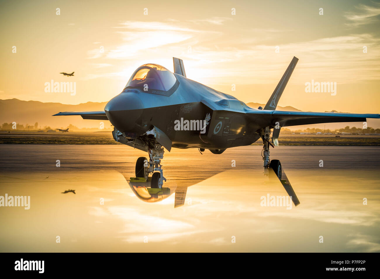 The sun sets behind an Australian F-35A Lighting II at Luke Air Force ...