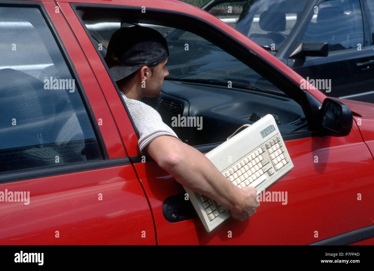 Man holding keyboard out of the car window, Berlin, Germany Stock Photo ...
