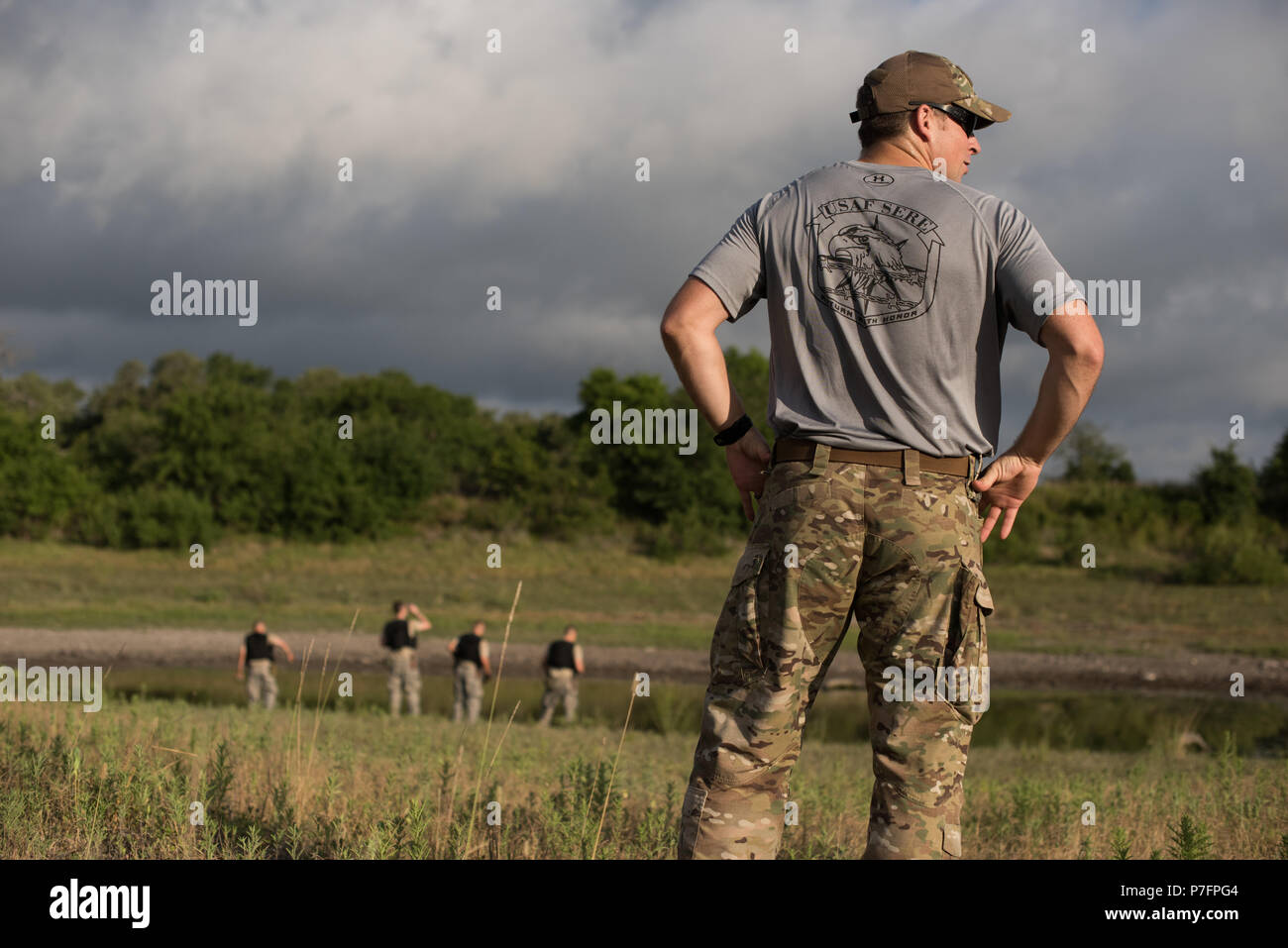 A Survival, Evasion, Resistance, and Escape instructor observes ...