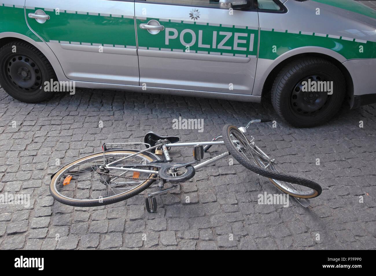 Bumped bicycle in front of a police car, symbol picture for accident ...
