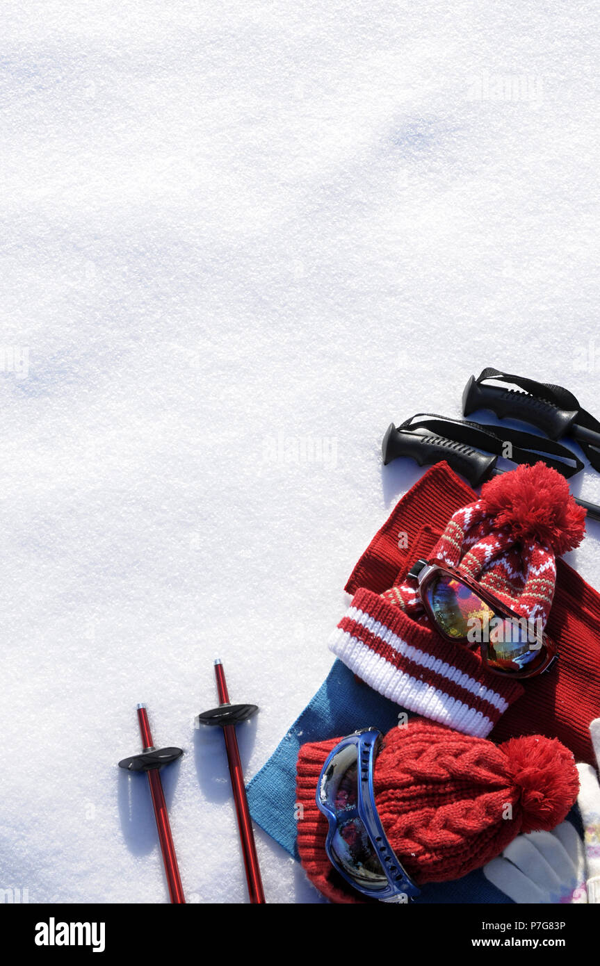 Winter snow sports background with ski poles, goggles, hats and gloves ...