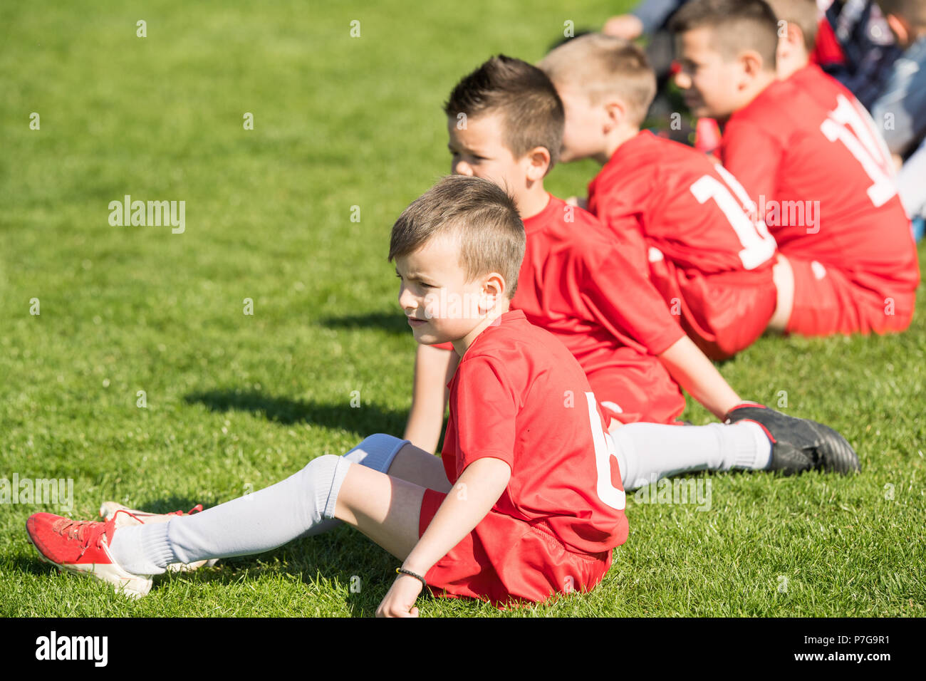 Kids soccer football - young children players sitting in out at match ...