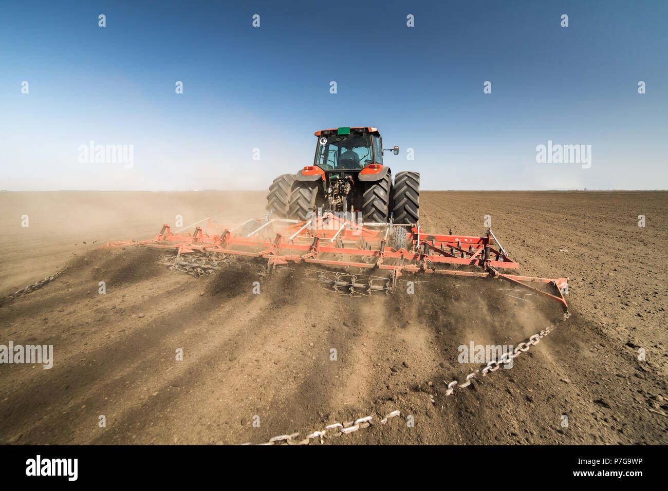 Tractor preparing land for sowing Stock Photo - Alamy