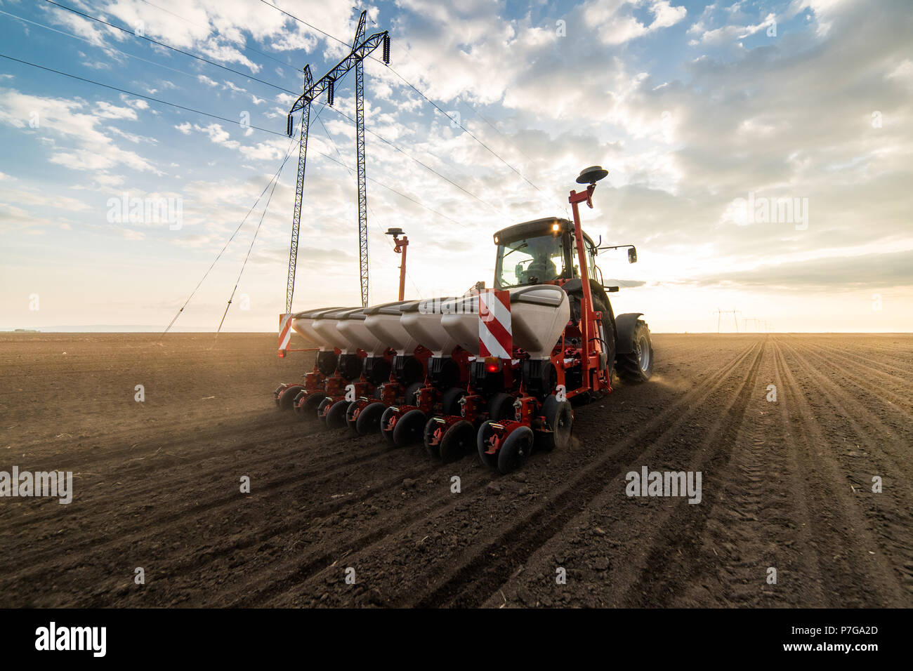 Farmer with tractor seeding - sowing crops at agricultural fields in spring Stock Photo - Alamy