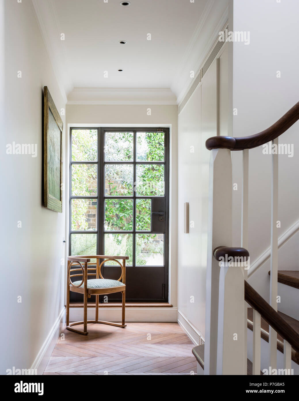 Chair in front of glass door Stock Photo - Alamy