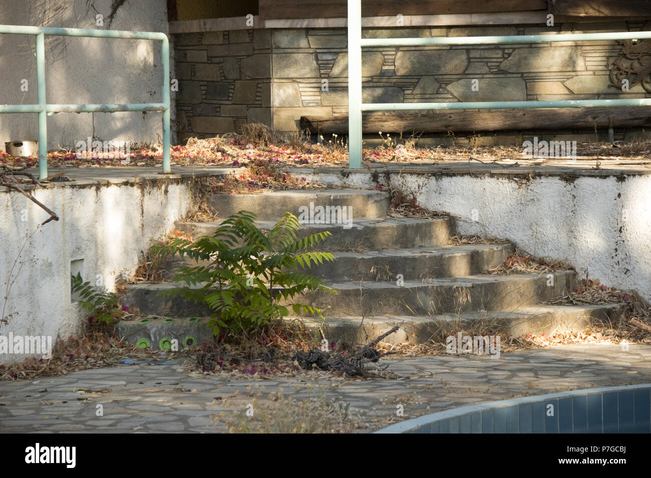 Dilapidated swimming pool in the remains of a hotel in Mirties village ...
