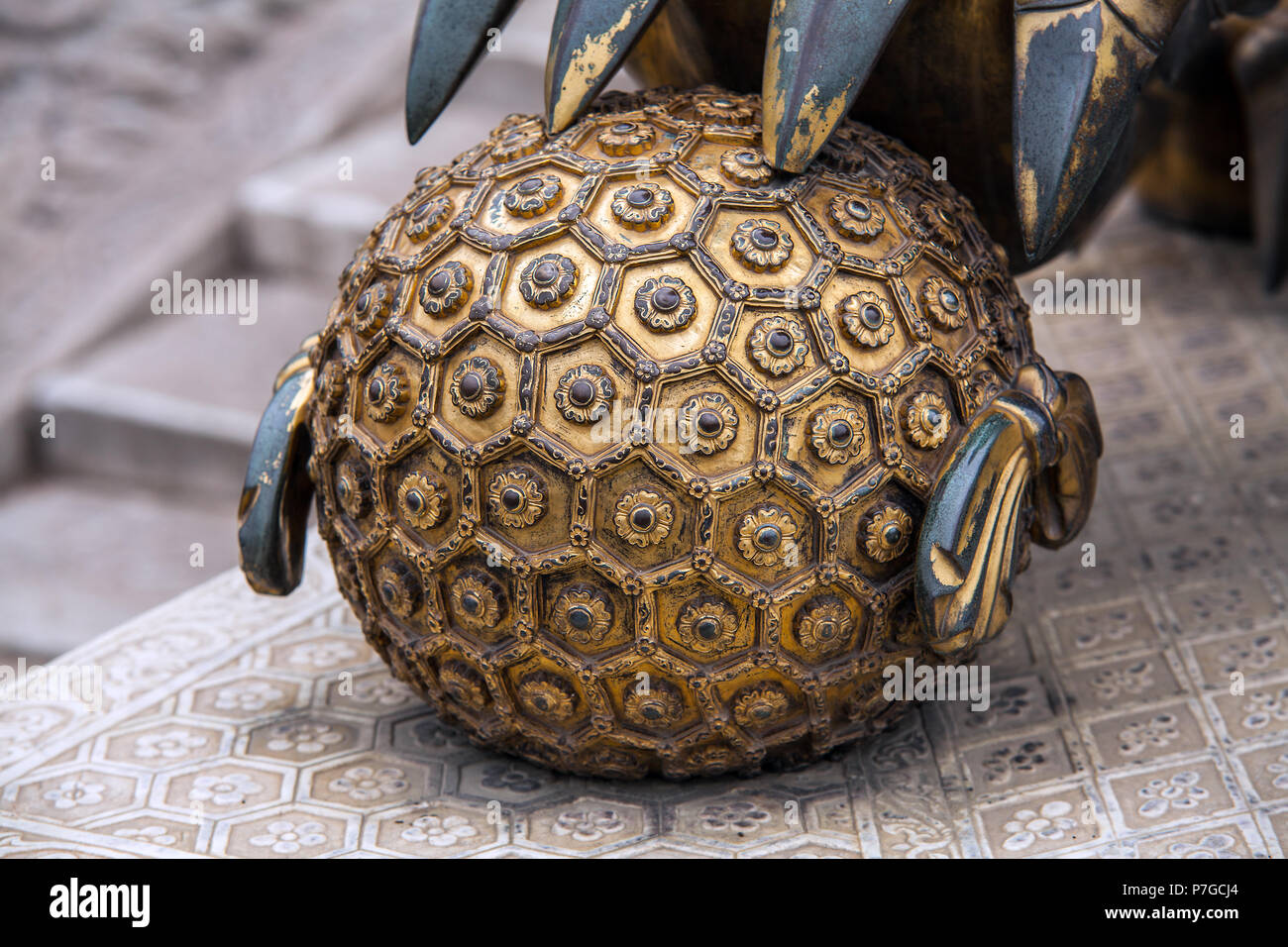 A male Lion Gatekeeper is holding a globe at Forbidden City, Beijing ...