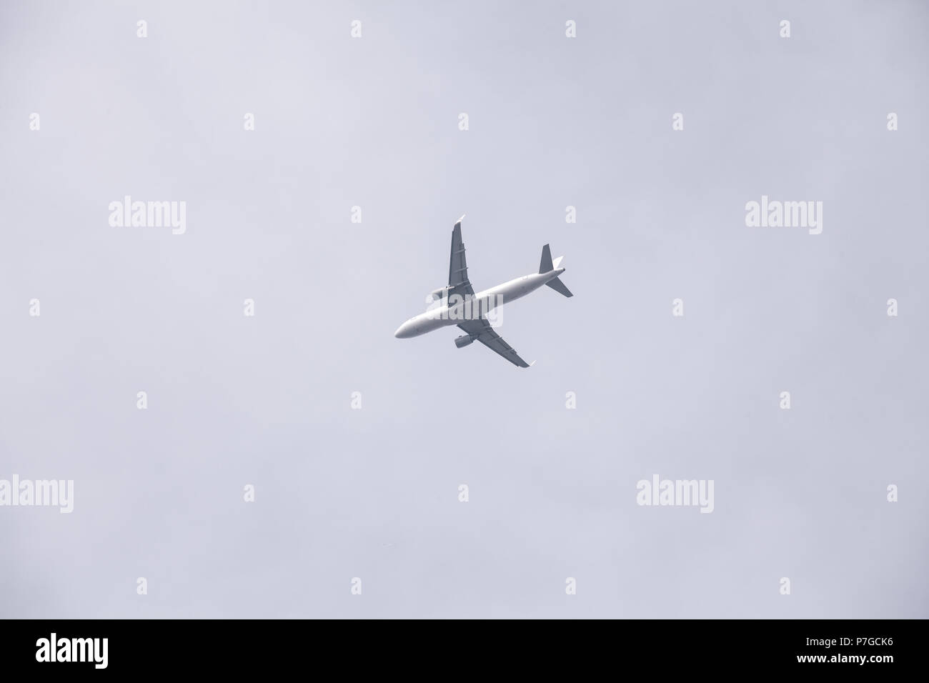 Passenger Airplane flying under the sky Stock Photo - Alamy