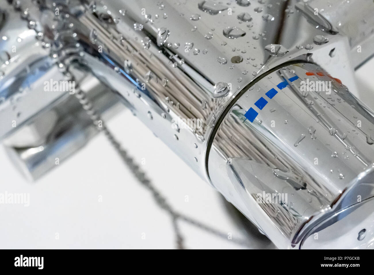 Close-up, shallow focus of a modern metal shower and bath hot and cold ...