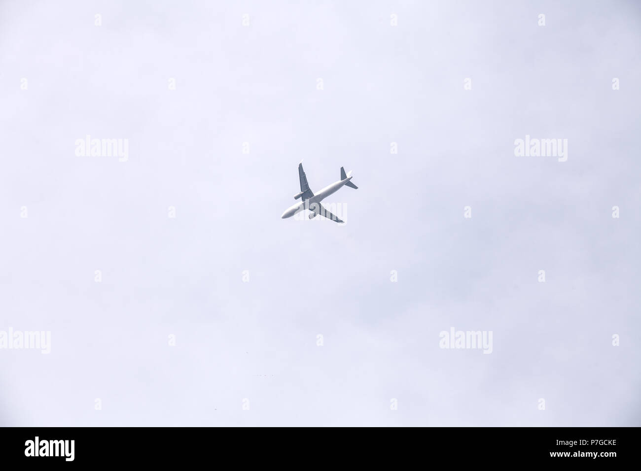 Passenger Airplane flying under the sky Stock Photo - Alamy