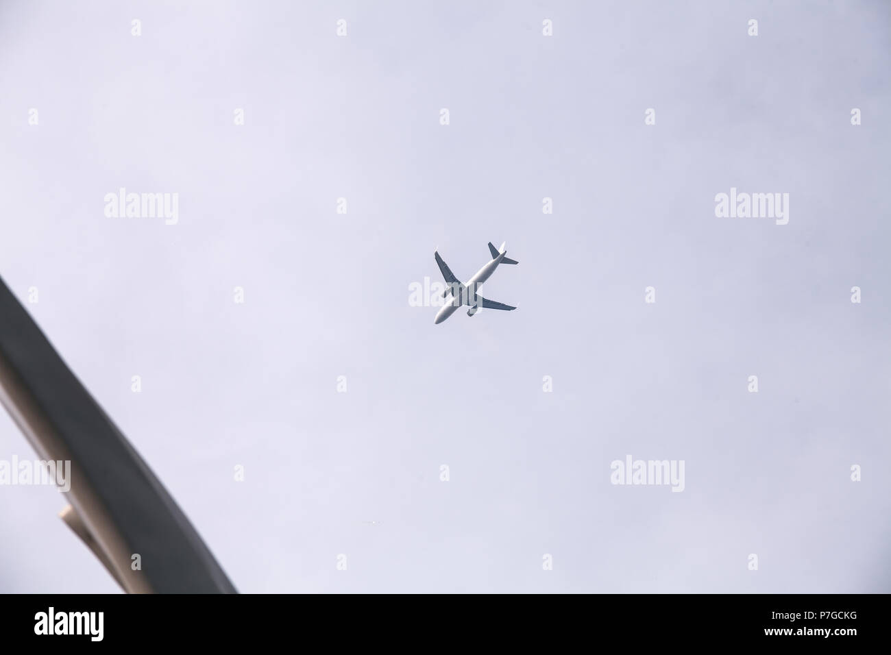 Passenger Airplane flying under the sky Stock Photo - Alamy