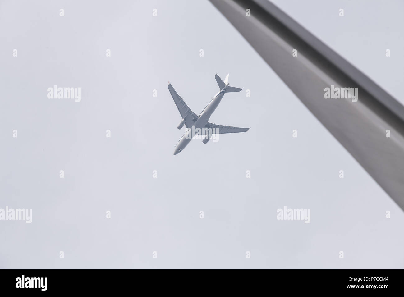 Passenger Airplane flying under the sky Stock Photo - Alamy