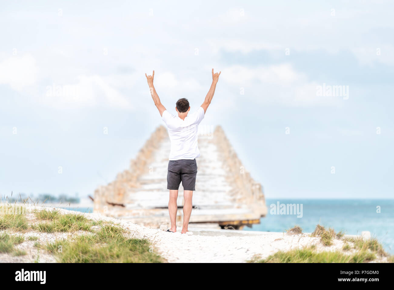 Young man standing in front of Knights Key-Pigeon Key-Moser Channel ...