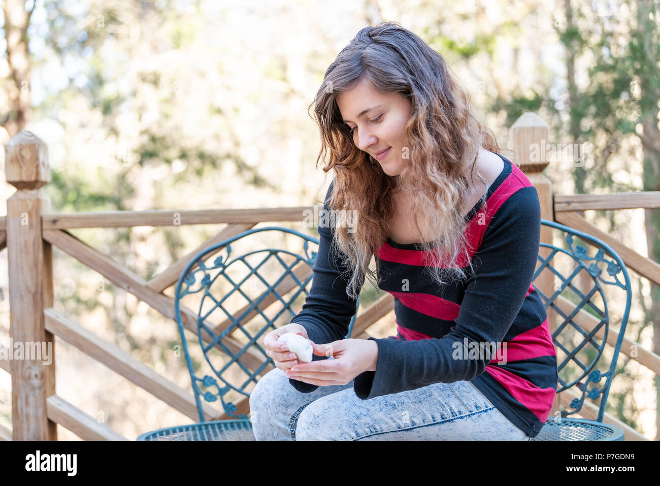 One Young Woman Sitting On Chair Holding Eating Piece Of Homemade Mochi Sticky Glutinous