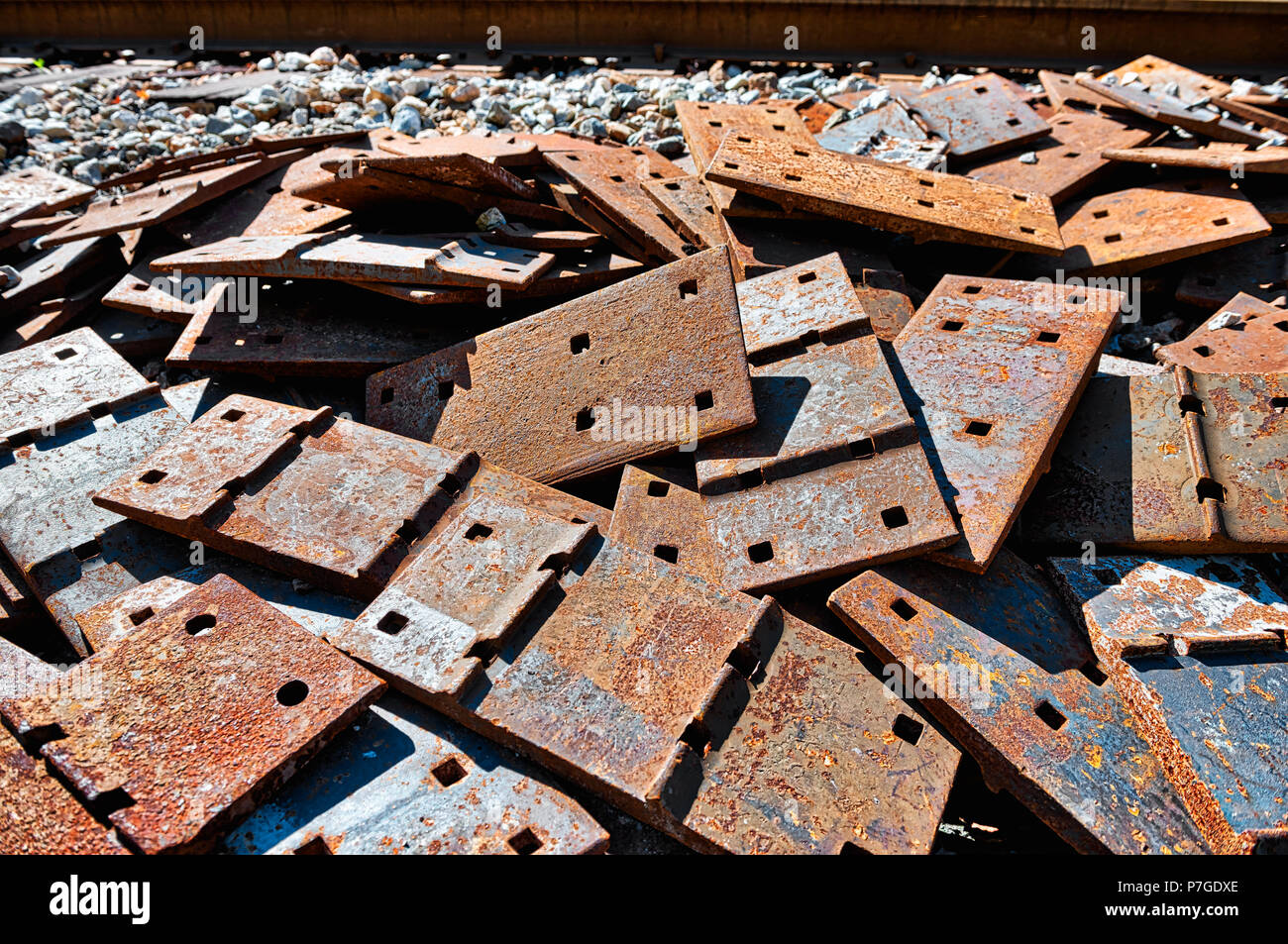 Pile of scrap rail railway railroad track rusty grungy metal plates ...