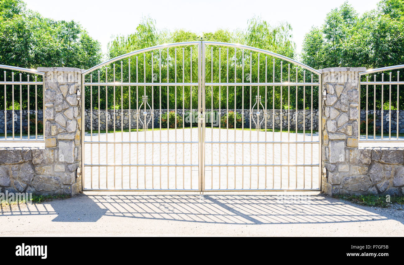 Chrome fence gate. Chromium Stainless steel fence on stone wall Stock ...