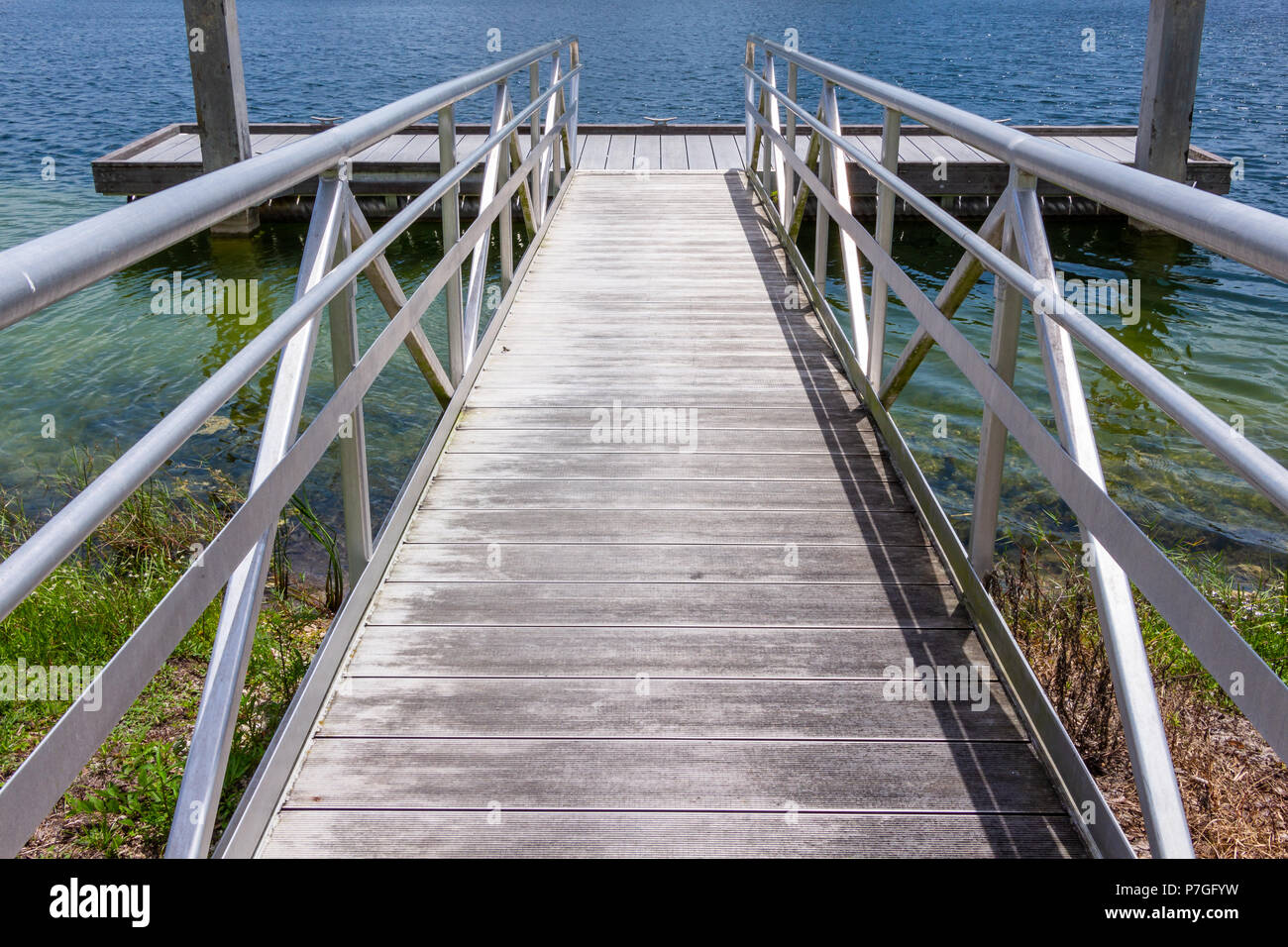 Ramp to boat dock or fishing platform on blue green lake - Vista View ...