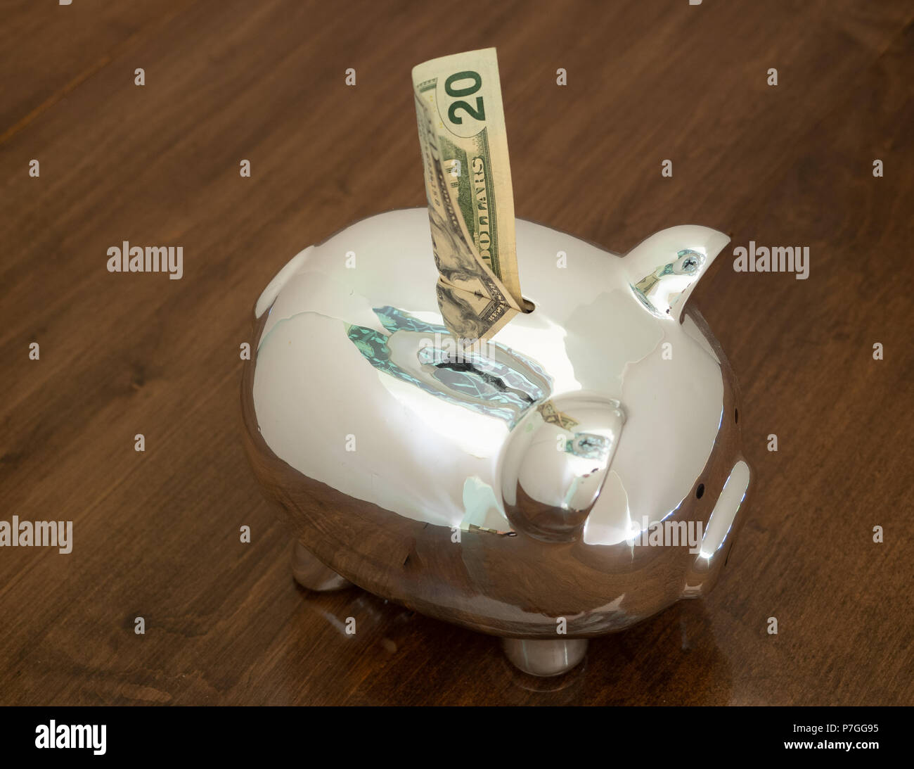 A shiny piggy bank with reflections photographed from above with a ...