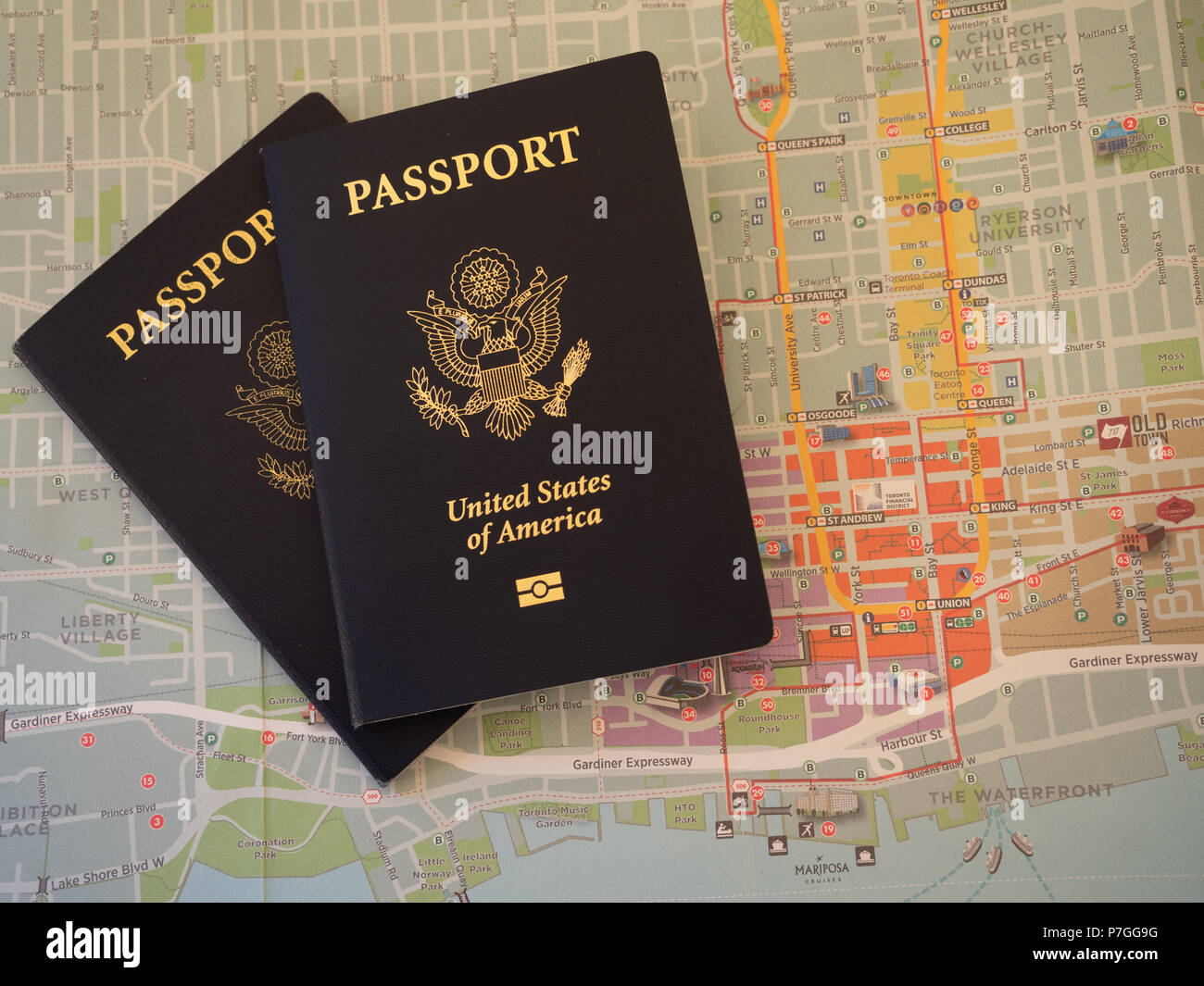 Two US Passports atop a colorful map. Photographed from above Stock ...