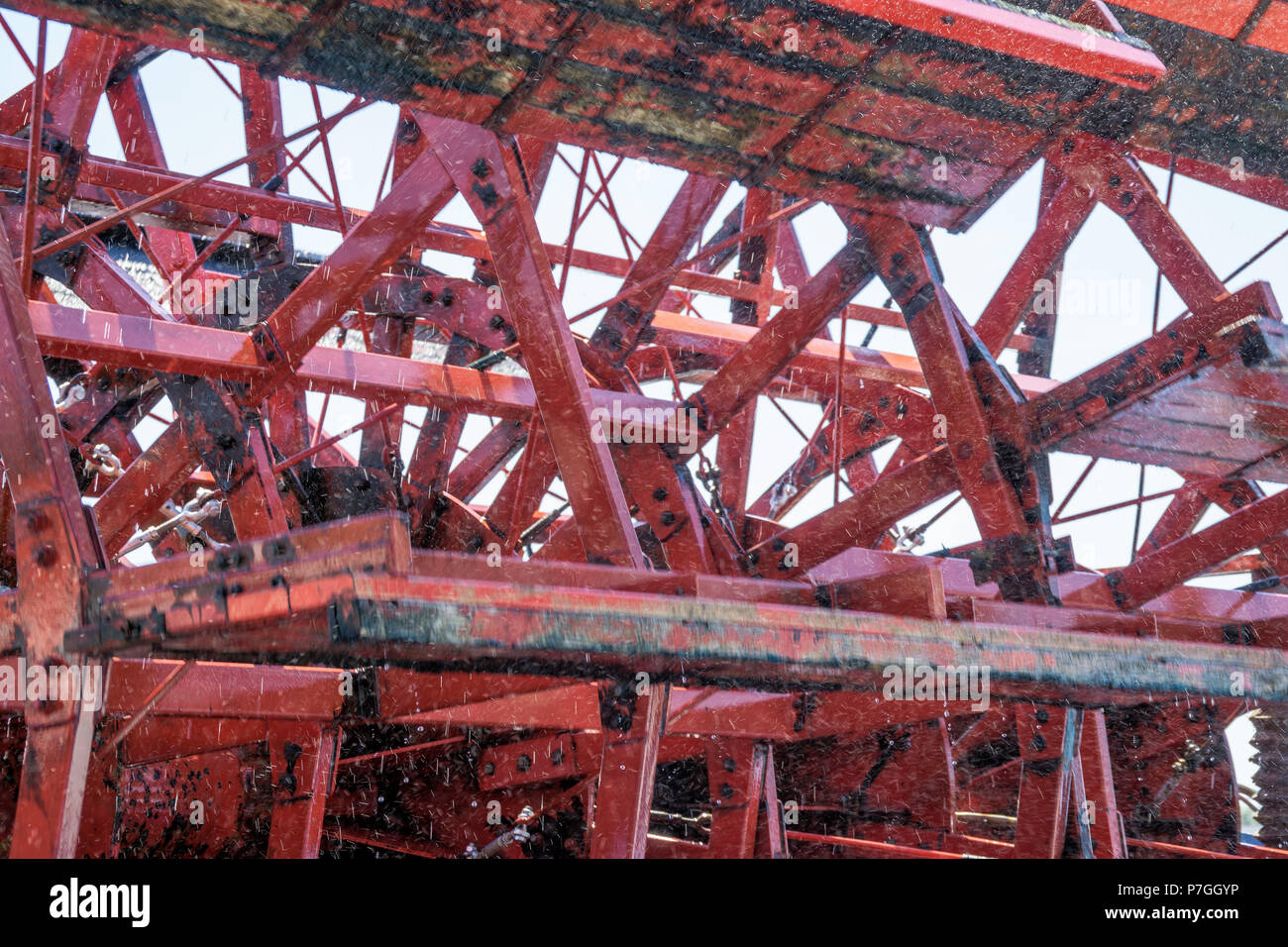 Detail view of a rotating red paddle wheel of a paddle wheel steamer ...