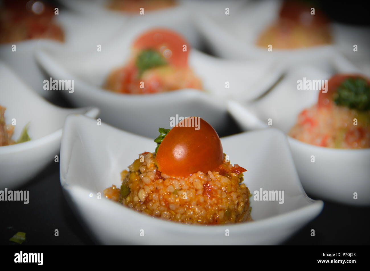 Couscous salad with tomato slices as starters served at a restaurant ...