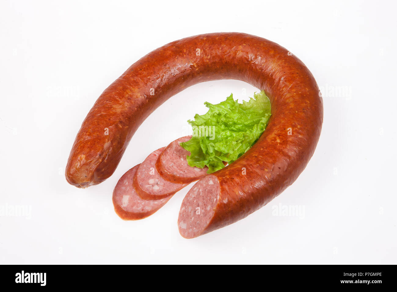 Sauage with greenery on isolated studio background Stock Photo - Alamy