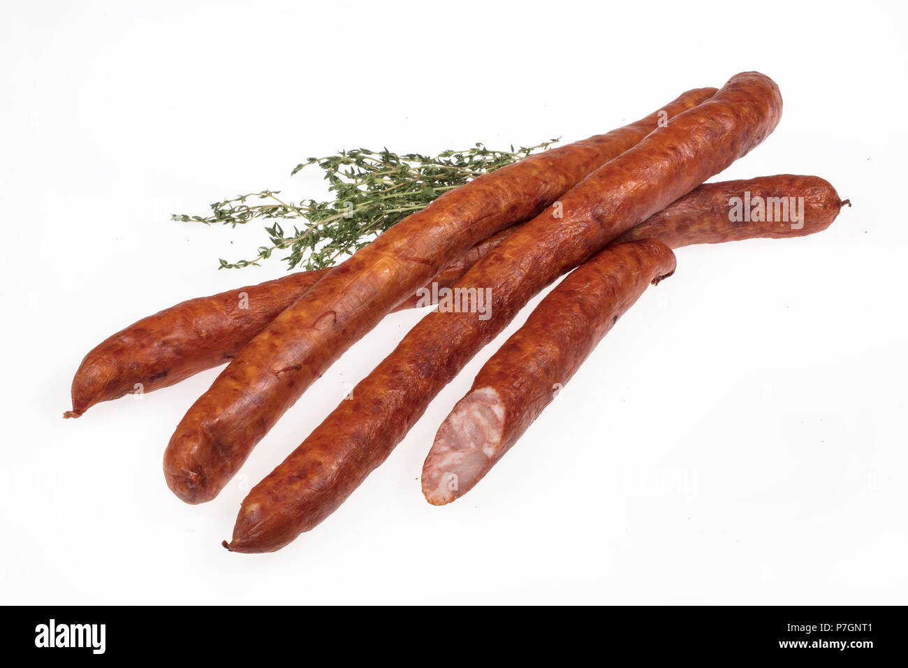 Sausge with greenery on an isolated studio background Stock Photo - Alamy