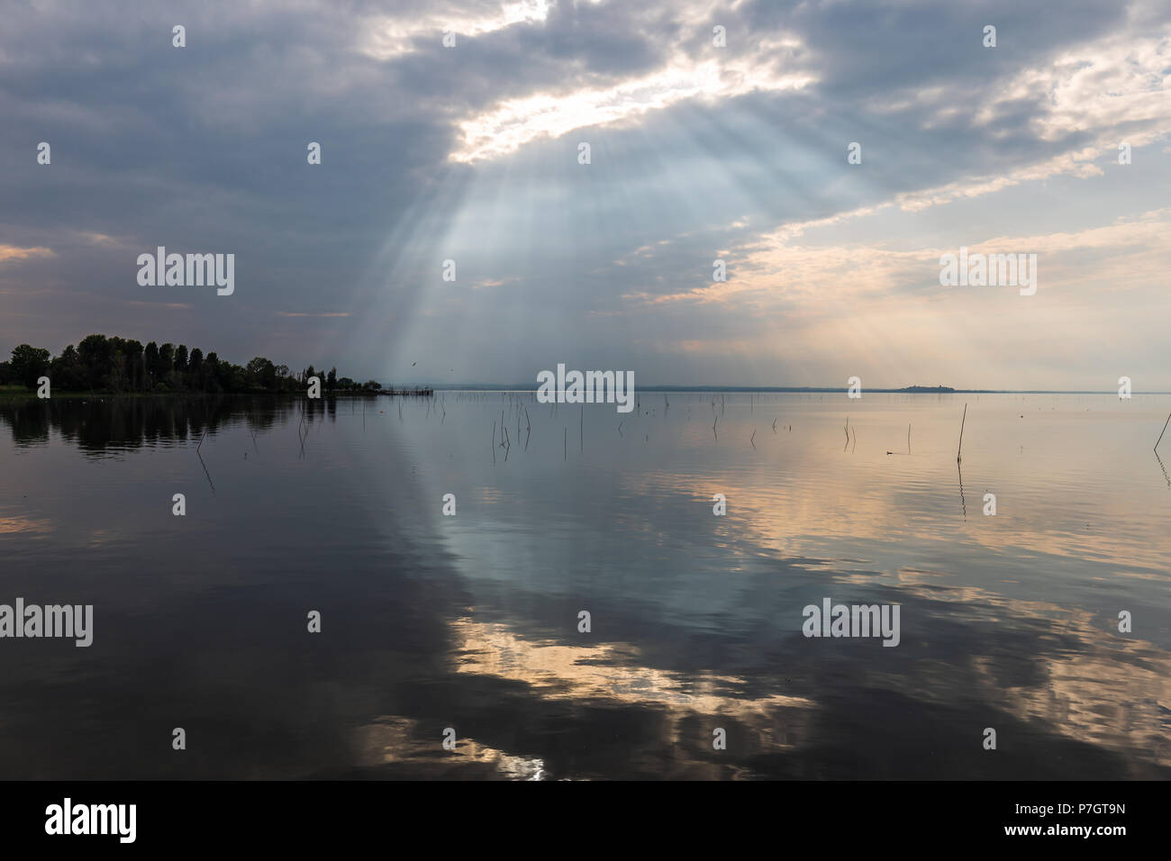 Perfectly symmetric and spectacular view of a lake, with clouds, sky ...