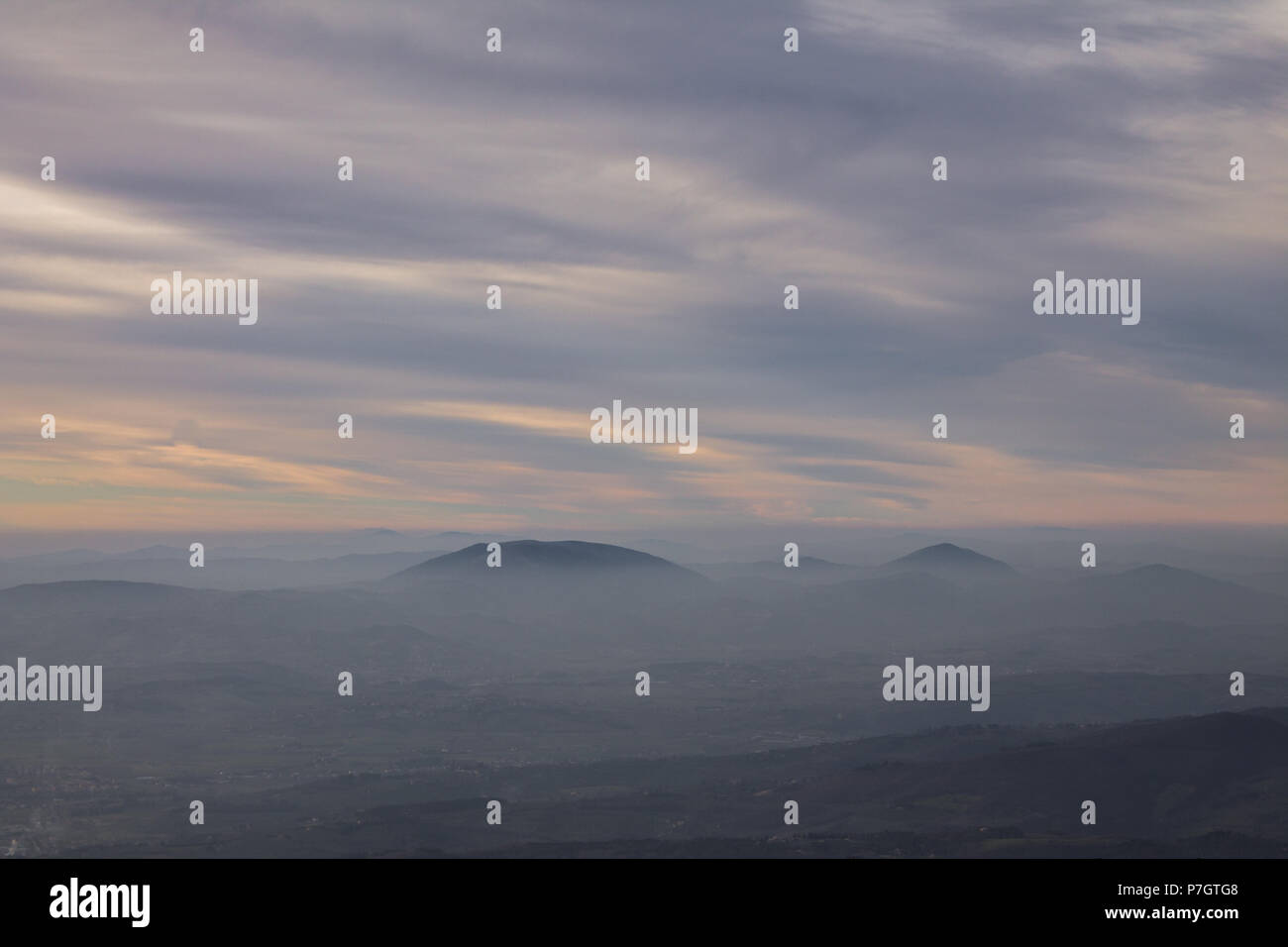 Subasio Mt. (Umbria, Italy), with sky covered by clouds and warm sunset ...
