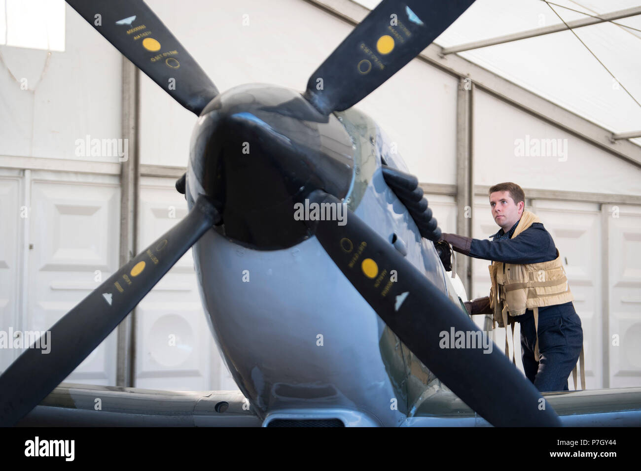 A reenactor looks at a Supermarine Spitfire Mk16-A on show at Horse ...