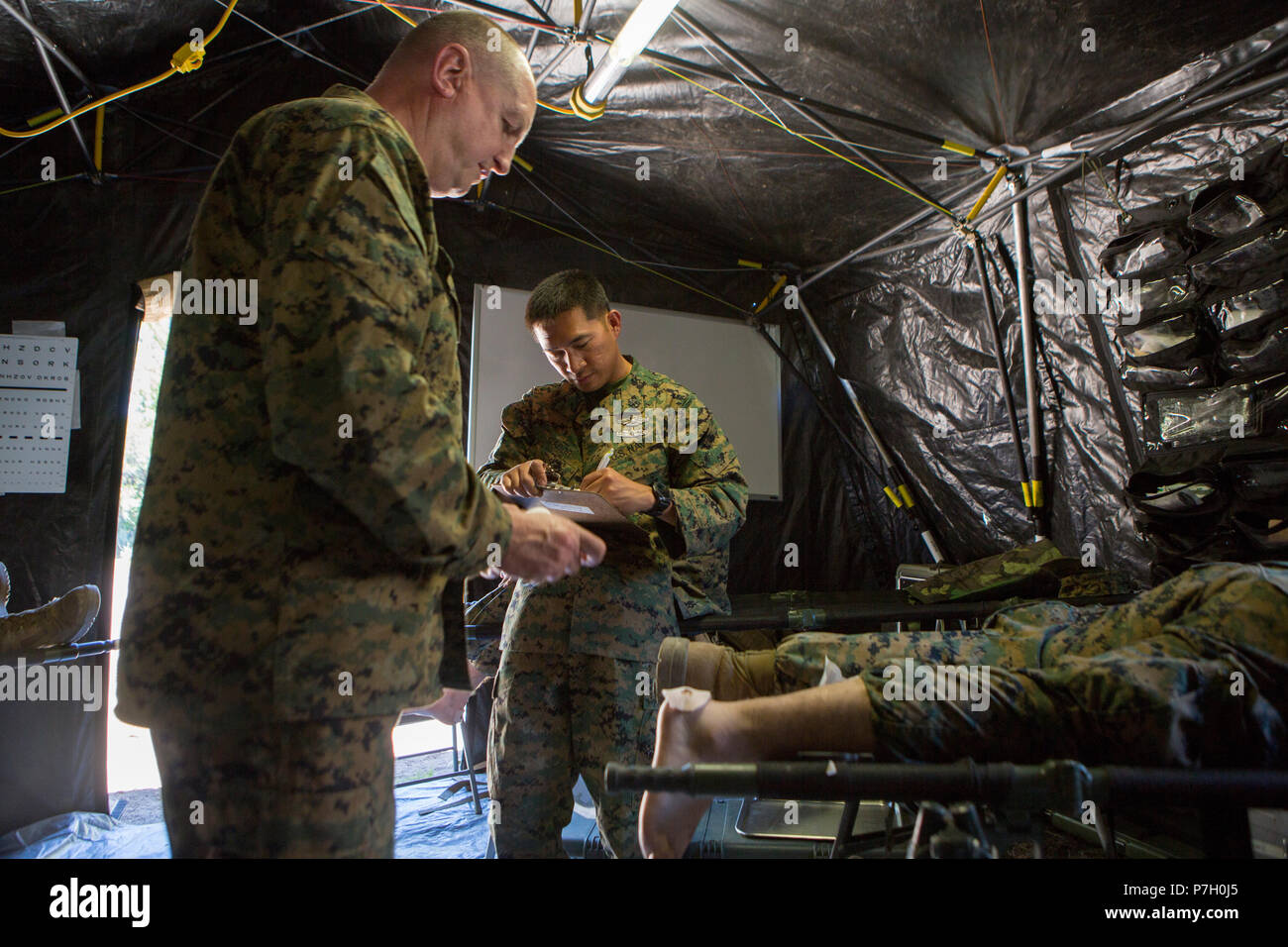 Lt. Cmdr. Martin Kelly (left), a system battalion surgeon, and Chief ...