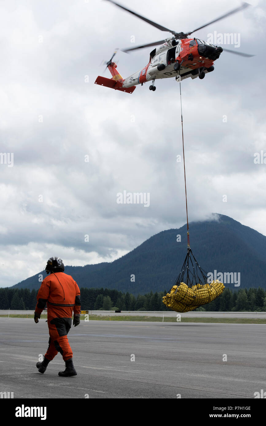 A Coast Guard Air Station Sitka MH-60 Jayhawk helicopter crew hoists ...