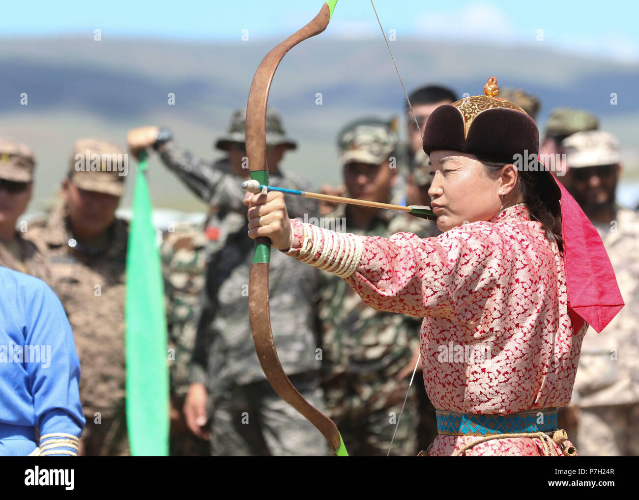 A traditional Mongolian archer shoots at a target during the Nadaam ...
