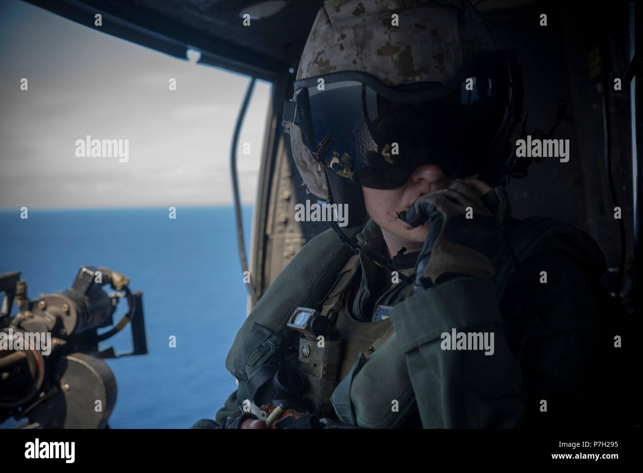 Cpl. Taylor Larson communicates with her crew during a live fire event ...