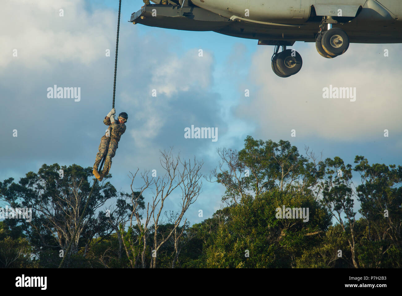 Sgt. Christopher Mante slides down a rope from an MV-22B Osprey during ...