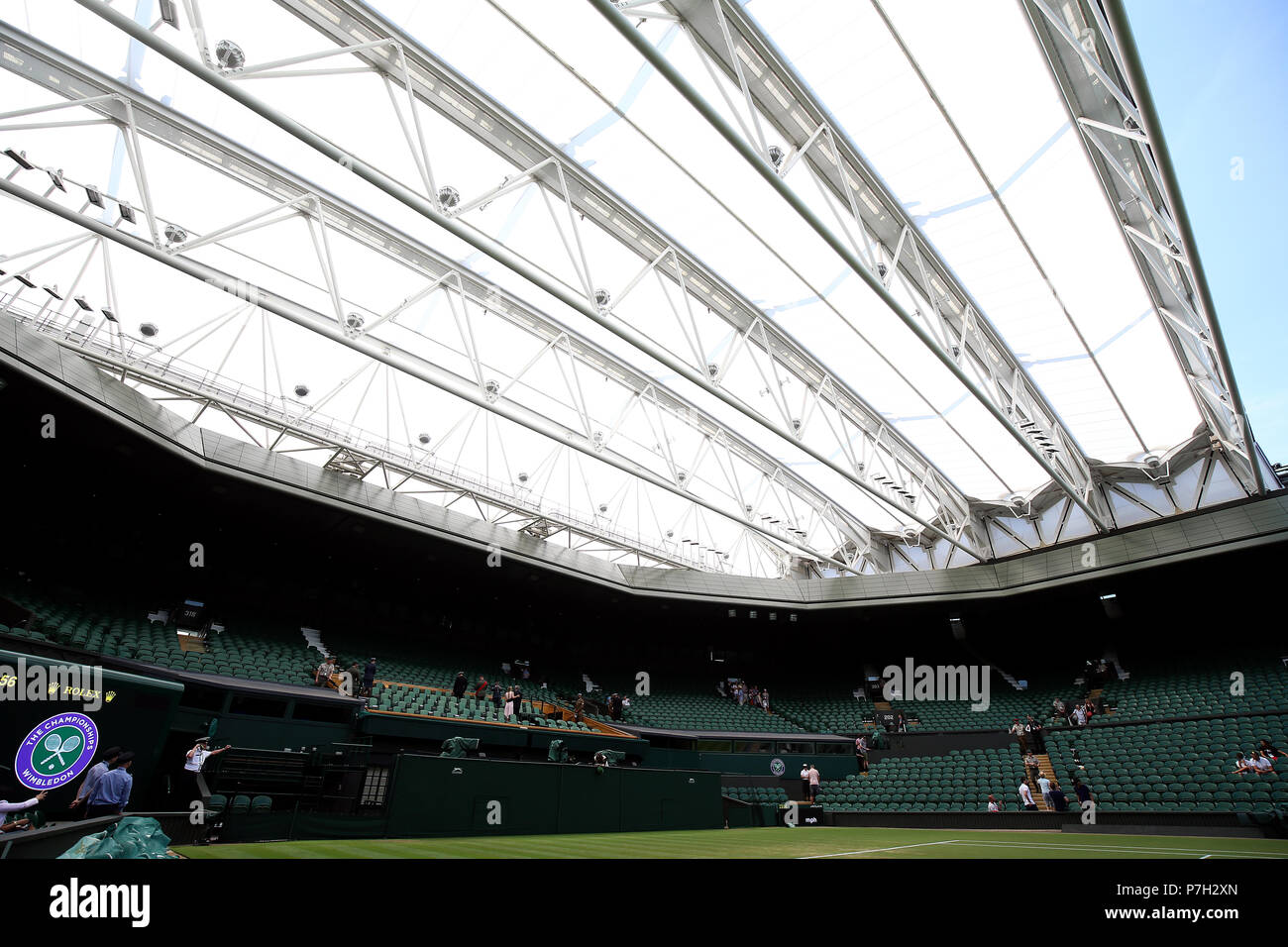 The centre court roof is partially closed to shelter the court and the ...
