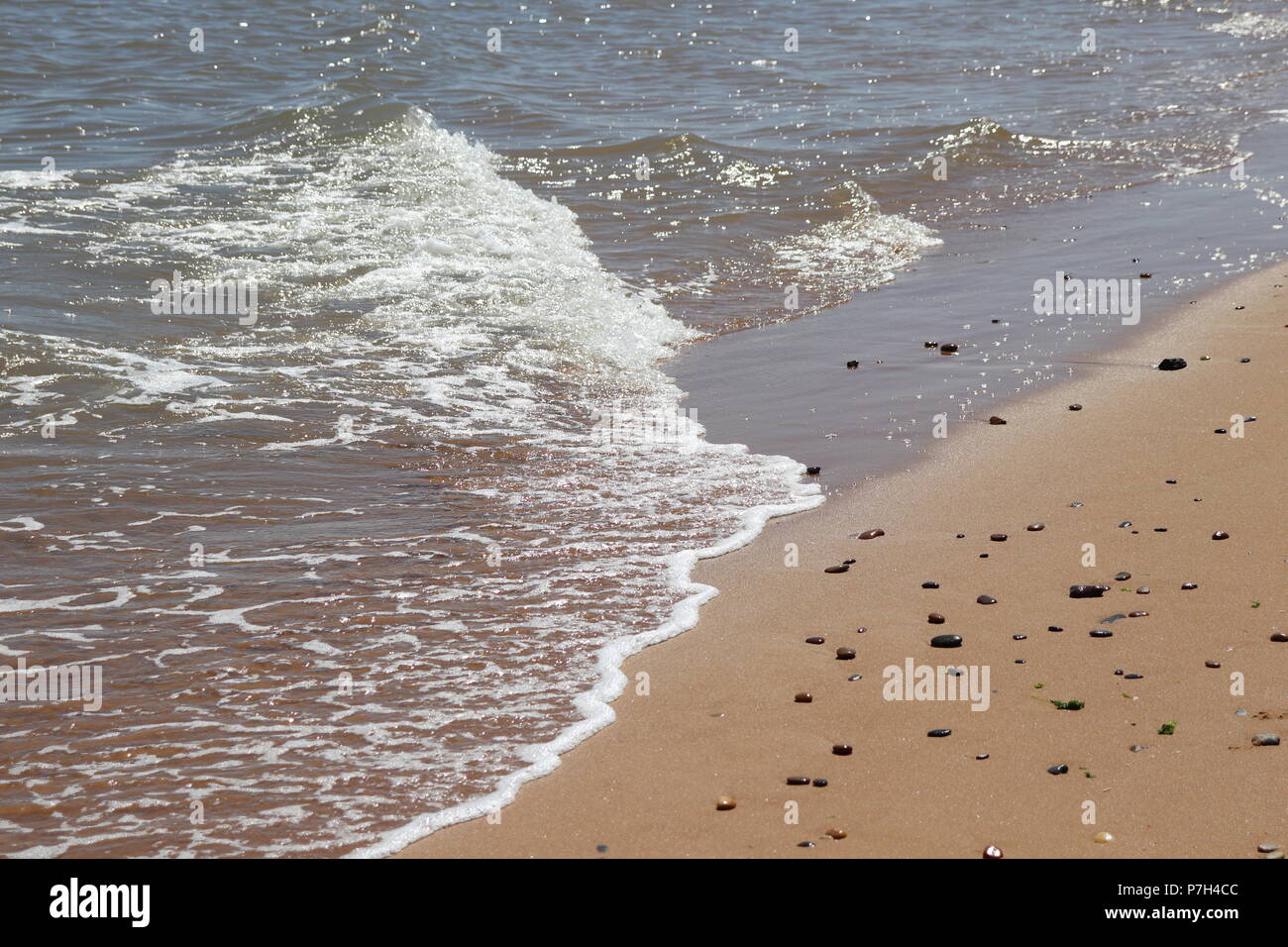 Waves arriving on beach Stock Photo - Alamy