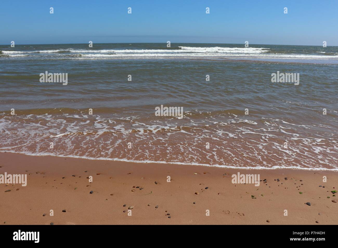 Waves arriving on beach Stock Photo - Alamy
