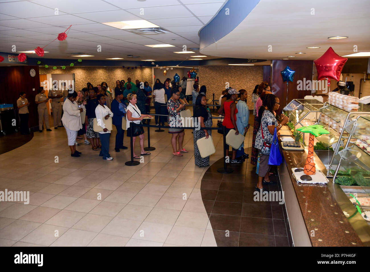 NMCP staff line up to enjoy the flavors of the Caribbean during a ...
