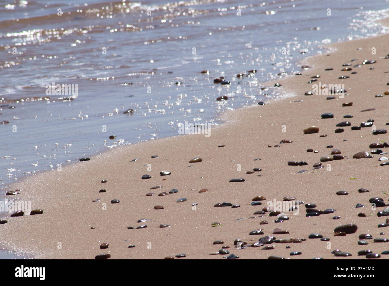 Waves arriving on beach Stock Photo - Alamy