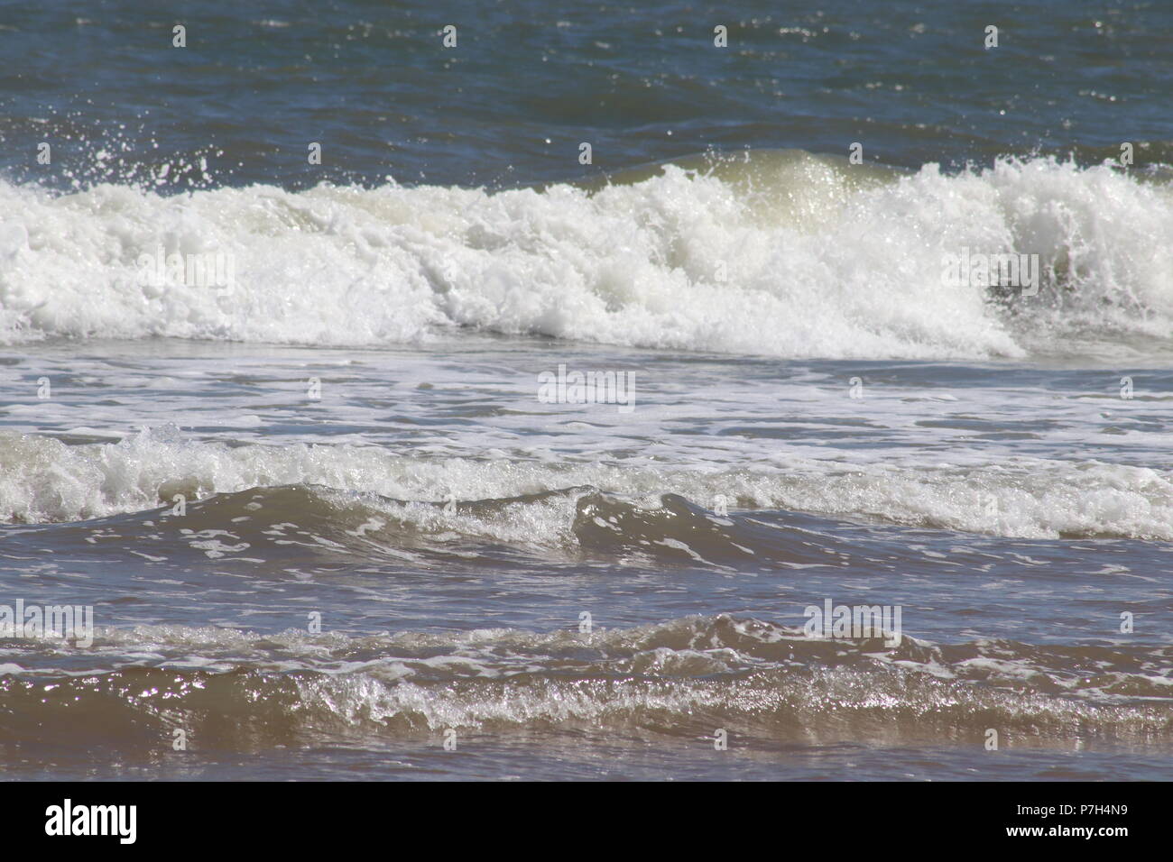 Waves arriving on beach Stock Photo - Alamy