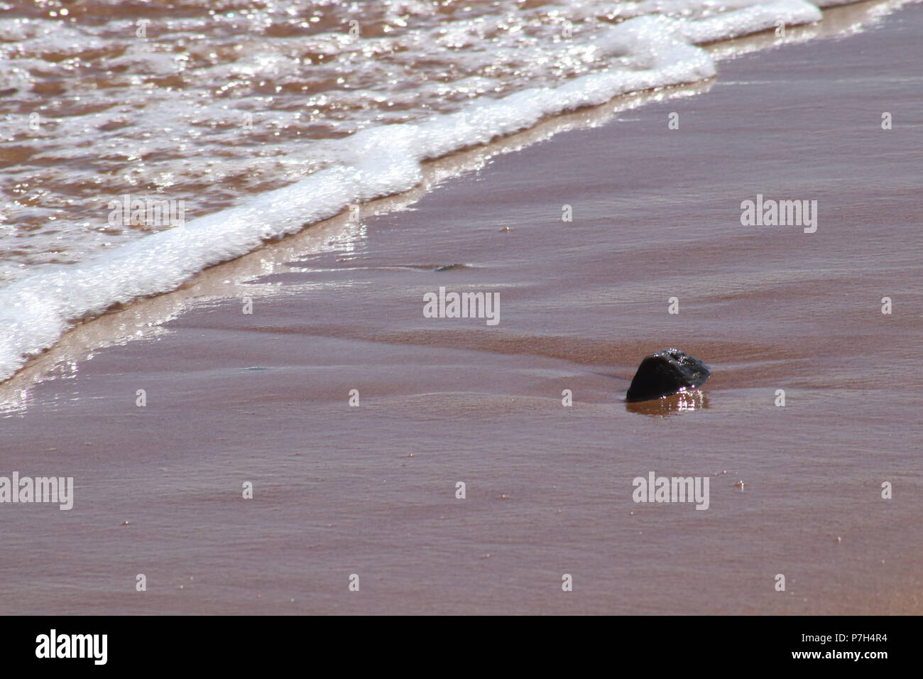 Waves arriving on beach Stock Photo - Alamy