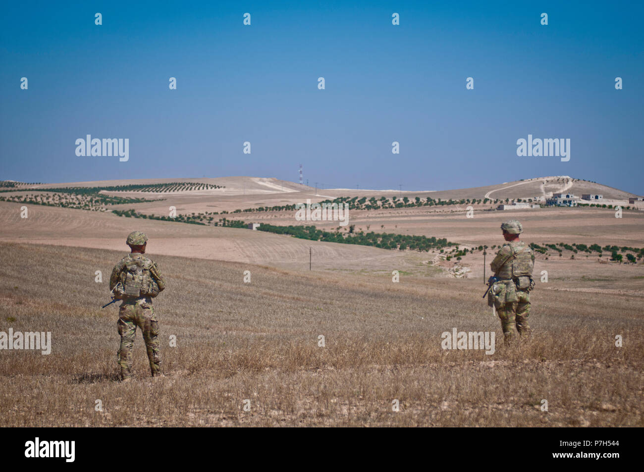 A U.S. Soldier looks through a scope at the Turkish military forces ...