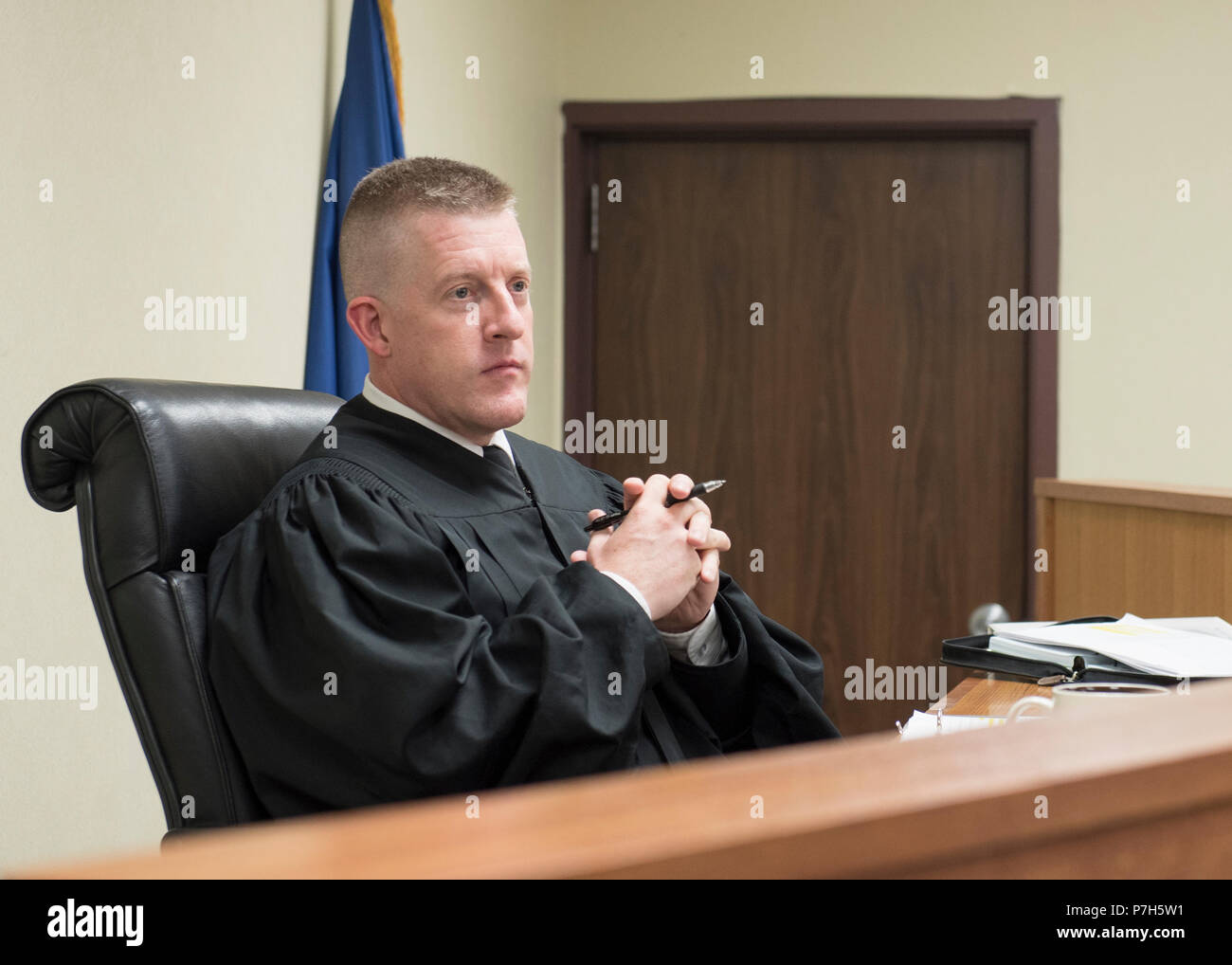 Lt. Col. Steven Neill, U.S. Army military judge, listens to the ...