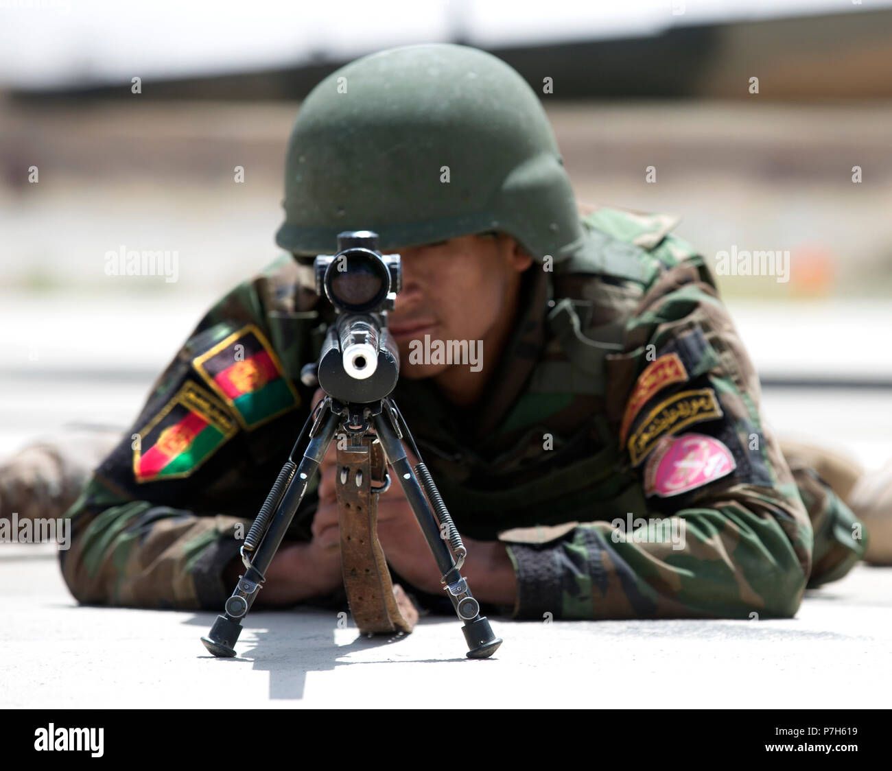 An Afghanistan National Army soldier takes up a security position while ...