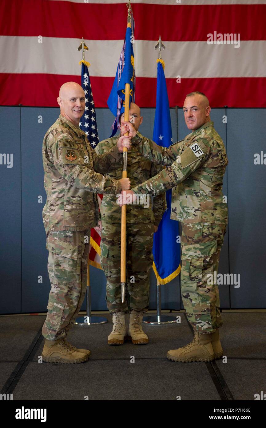 Colonel John Grimm, 90th Security Forces Group commander, passes the ...