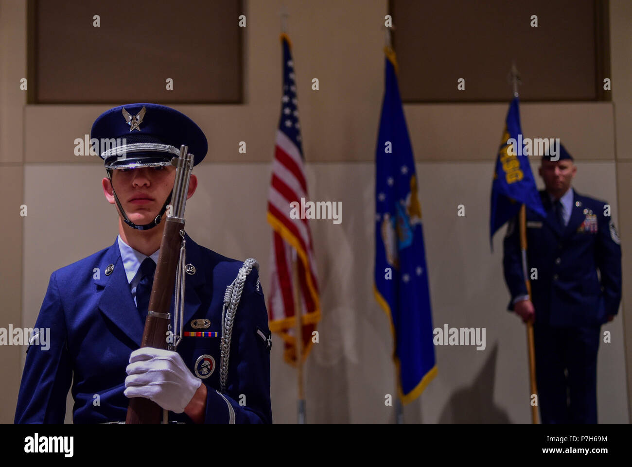 A Mile High Honor Guard member stands at attention during the beginning ...