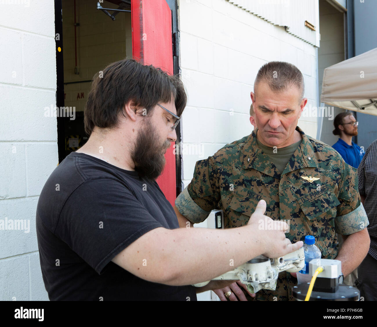 U.S. Marine Brig. Gen. Karsten S. Heckl watches a product demonstration ...
