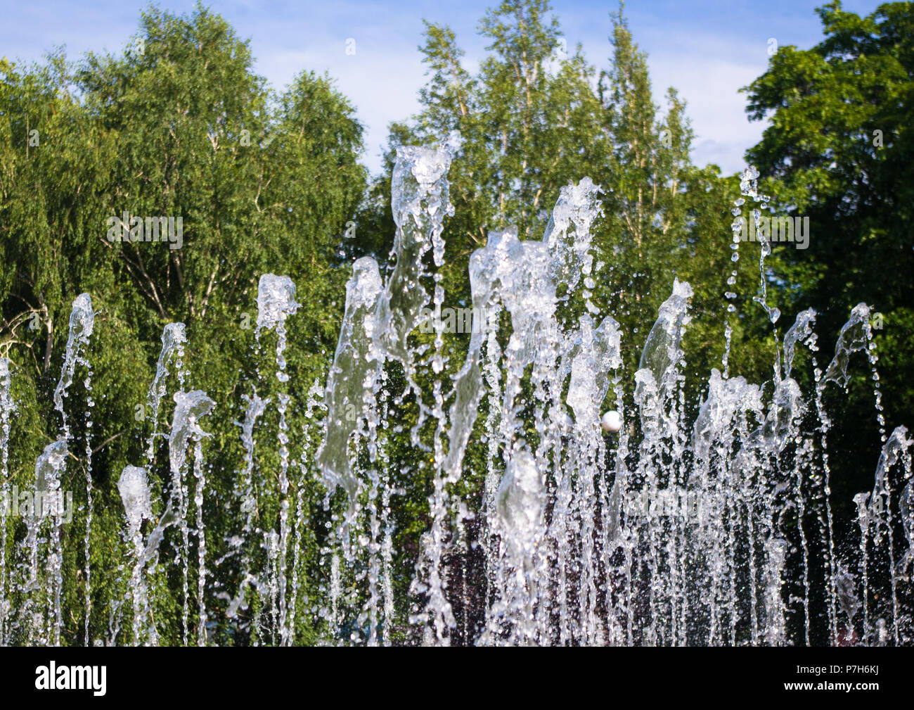 Fountain in city park on hot summer day, beautiful bright streams of ...