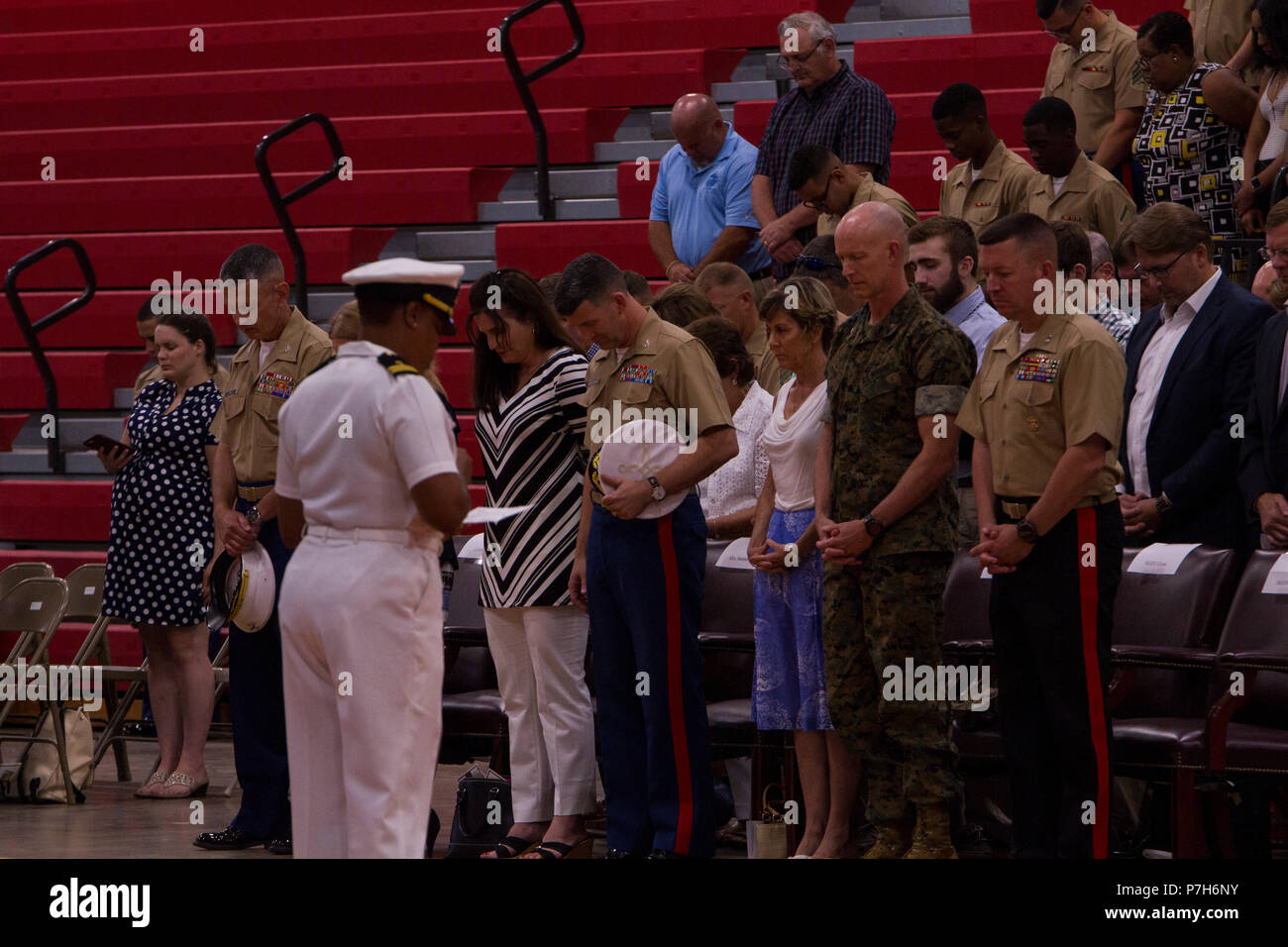 Marines pray during the invocation portion of a change of command ...